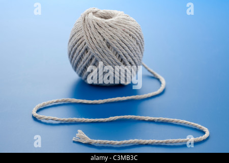 Ball of twine unraveling Stock Photo - Alamy