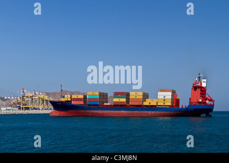 A container ship entering Port Sultan Qaboos in Muscat, Oman Stock ...