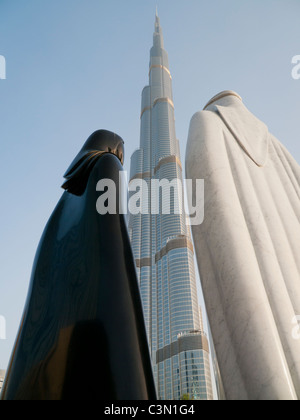 UAE, Dubai, statue 'Together' by Lutfi Romhein with the Burj Khalifa ...