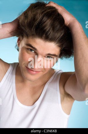 Portrait of Young Man With Raised Hands at Chest Stock Photo - Alamy