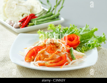 Thai style green papaya salad with shrimp and prawn crackers in bowl ...