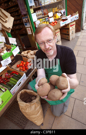 Shopkeeper outside his organic wholefoods shop in Totnes, Devon , UK ...