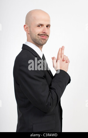 Man showing gun sign, portrait Stock Photo - Alamy