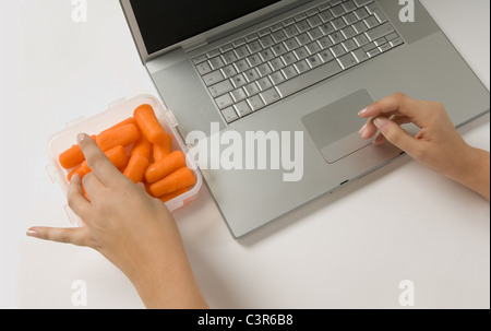 Healthy snack at work - hand reaching for nuts on desk, office setup ...