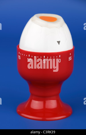 egg timer and eggs on blue background Stock Photo - Alamy