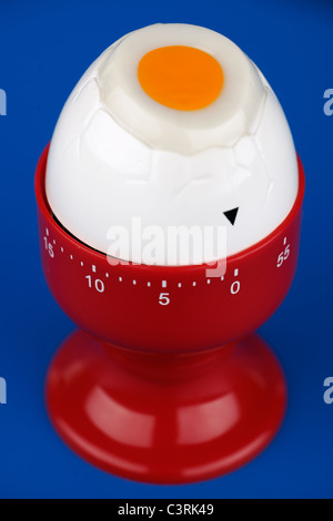 egg timer and eggs on blue background Stock Photo - Alamy