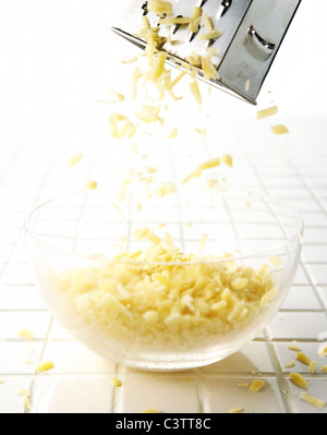 Grated cheese falling Stock Photo - Alamy