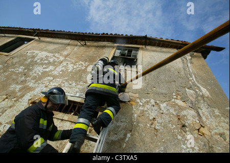 Fireman climbing a ladder Stock Photo - Alamy