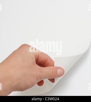 Hand turning the page Stock Photo - Alamy