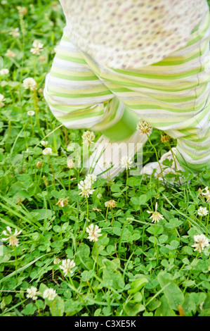 Toddler taking first steps in a park Stock Photo - Alamy