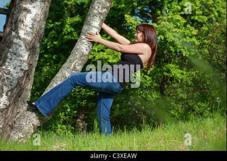 Young woman playing with birch tree Munich Bavaria Germany Stock Photo ...