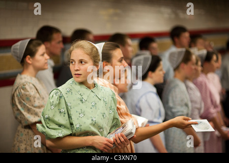 Mennonite church members sing hymns and pass out brochures as they ...