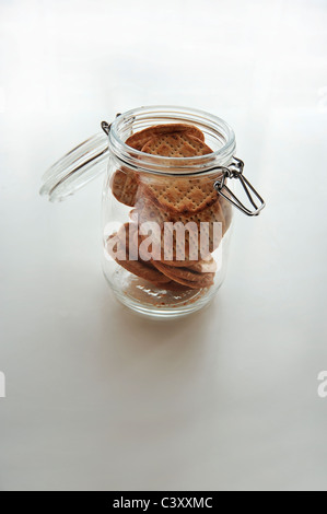 Pile of round crackers in glass bowl on white background with clipping ...