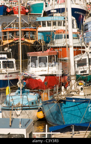 Small fishing boats landing their catch in Largs Harbour on the Firth ...