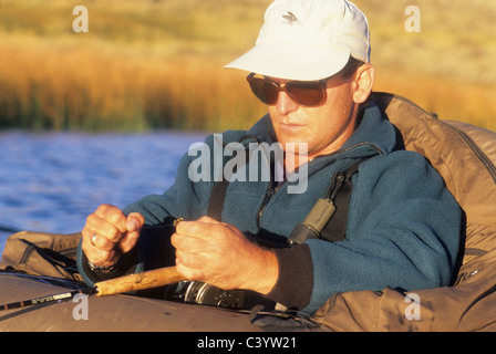 Man fly fishing at Kirman Lake in the Sierra Nevadas in a float tube ...