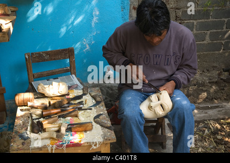 Wood carver artist Felipe Horta works crafting a traditional Purepecha ...