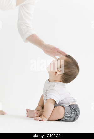 Hand caressing a baby Stock Photo - Alamy