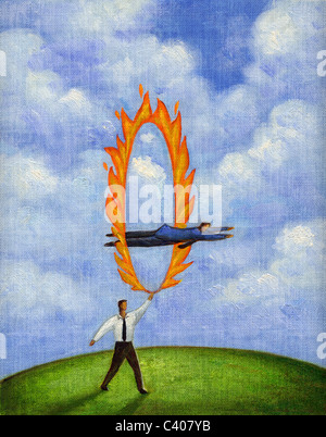 A man is jumping through a ring of fire during the display of the ...