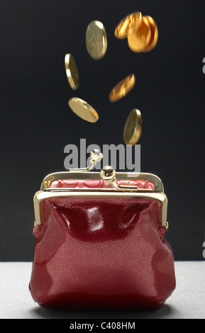 Coins falling into a purse Stock Photo - Alamy