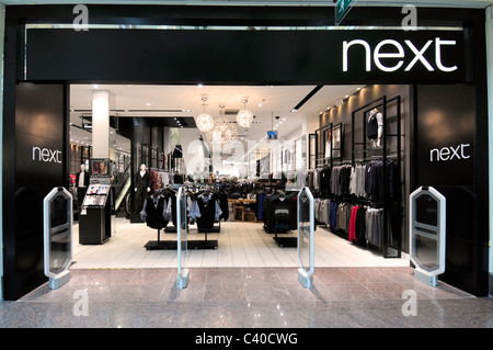 Large Next store indoor mall with escalator stairway & shopping sign ...