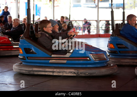 Riding the dodgems in the fun fair on South Pier,Blackpool,Lancashire ...