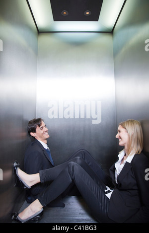 Colleagues flirting in elevator Stock Photo - Alamy