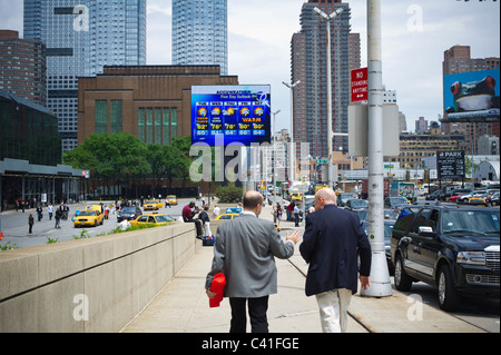 A giant illuminated billboard displays the five-day weather forecast ...
