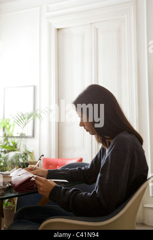 Woman going over her finances Stock Photo - Alamy