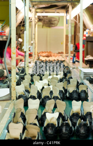 The conveyor on a shoes factory with shoe and sole. Mass production of ...