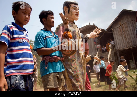A man wearing a traditional Khmer costume is marching in a parade on a ...