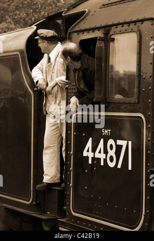steam train drivers dressed in blue uniforms fatigues Stock Photo - Alamy