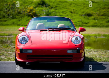 Front view of a red Porsche parked in a car park with visible number ...