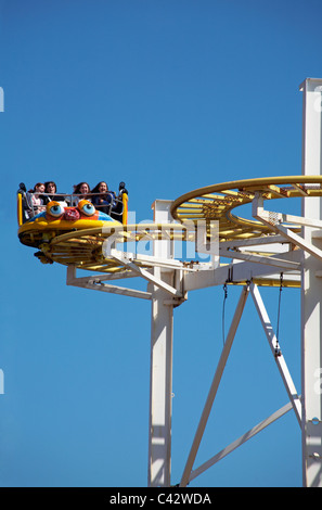 Three people on the Crazy Mouse roller coaster ride on Brighton Pier ...