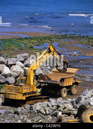 heavy machinery moving giant stone boulders building sea defences at ...