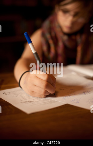 Teenage girl doing maths math sitting on floor writing on whiteboard ...