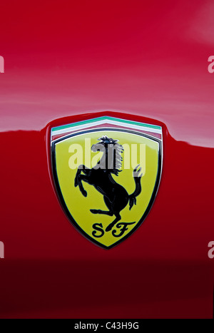 A Ferrari badge on a red car close up detail Stock Photo - Alamy