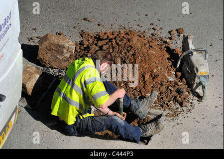 United Utilities operative investigating domestic water leak Stock ...