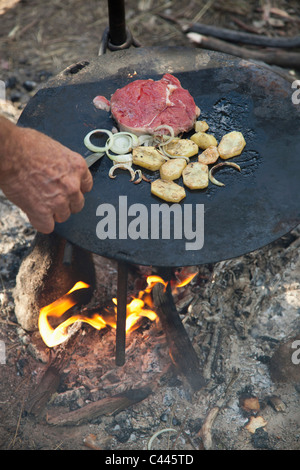 Meat cooking over a wood fire at the Minam River Lodge in Oregon's ...