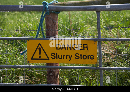 Danger slurry store notice on gate by field in the countryside in UK ...