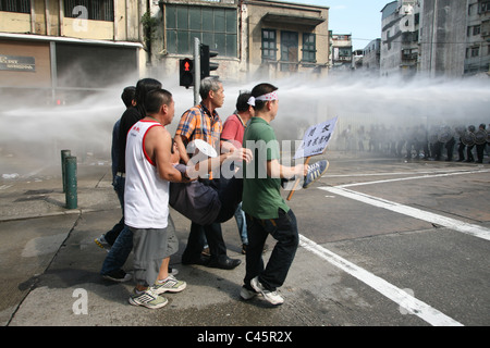 Bleeding man carried out of demonstration Stock Photo - Alamy
