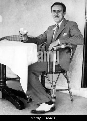 American animator and producer Walt Disney stands behind his wife ...