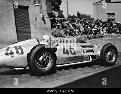 Racing driver Hermann Lang (in front) leads the field and wins the ...