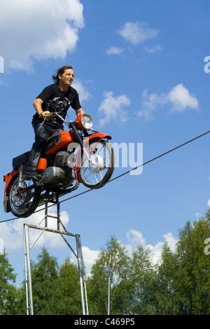 motorcycle driver balancing on rope Stock Photo - Alamy
