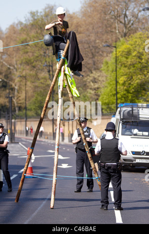 Protesters sit on top of tripods outside the London office of EDF ...
