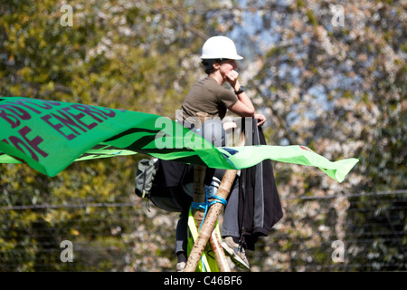 Protesters sit on top of tripods outside the London office of EDF ...