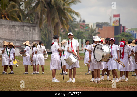 school girls in uniform, members of a marching band during a parade in ...