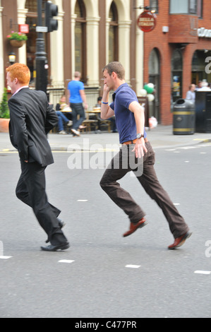 Man running across busy road talking on mobile phone Stock Photo - Alamy