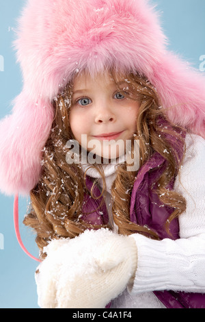 Lovely child girl, wearing blue summer dress and pink bolero, stacking ...