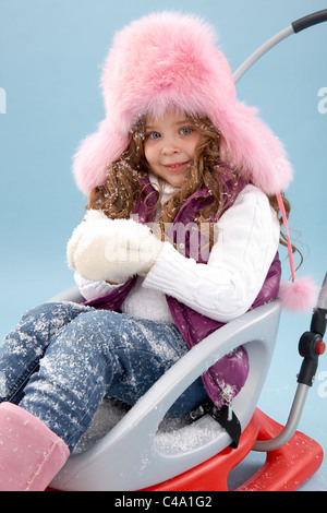 Lovely child girl, wearing blue summer dress and pink bolero, stacking ...