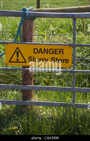 Danger slurry store notice on gate by field in the countryside in UK ...